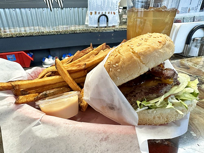 The burger that launched a thousand napkins. Sesame seed bun standing guard over a masterpiece of American culinary engineering.