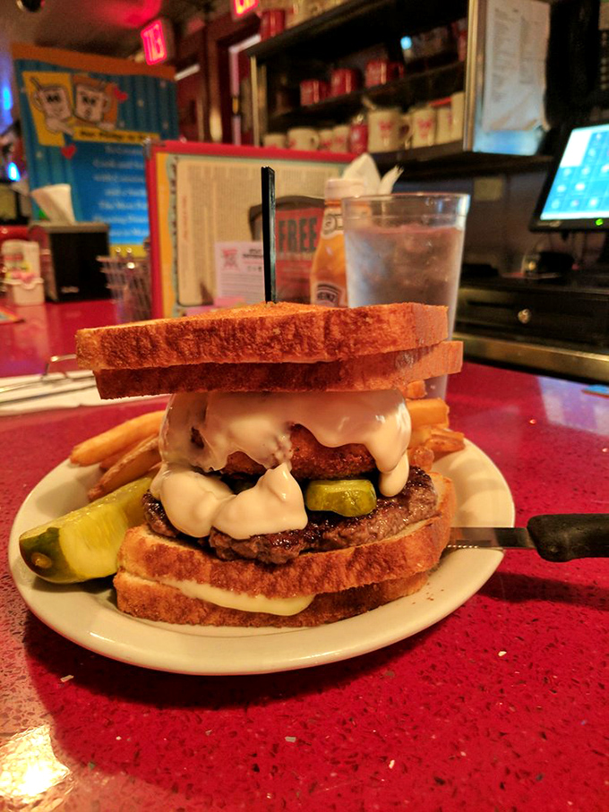 Not sure if it's a burger or an engineering marvel&mdash;meat and pickles sandwiched between two grilled cheeses. America's answer to the Eiffel Tower.