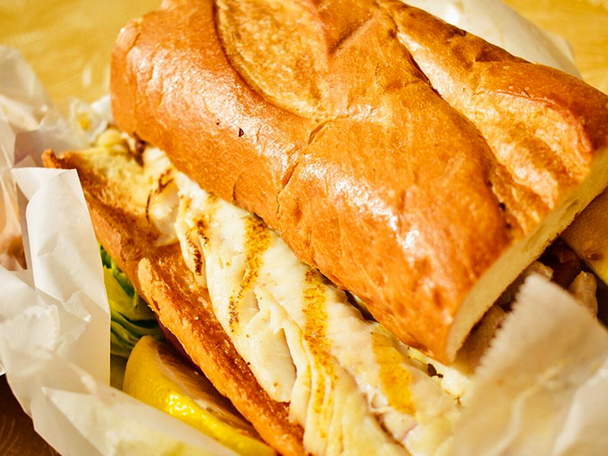 This isn't just a fish sandwich&mdash;it's architectural genius with layers of perfectly seasoned fish, crisp vegetables, and pillowy bread.