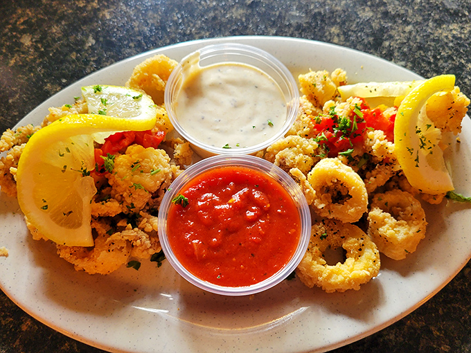 Golden calamari that crunches like a promise kept. Tender inside, crispy outside, with two dipping sauces playing good cop/bad cop with your taste buds.