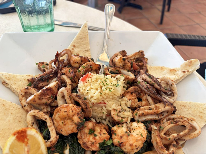 A star-shaped arrangement of calamari and shrimp that makes you wonder why all food isn't served on a throne of toasted pita points.