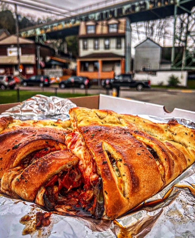 This isn't just a calzone&mdash;it's a magnificent carb fortress protecting precious cheese and toppings. The kind of meal that demands a post-consumption nap.