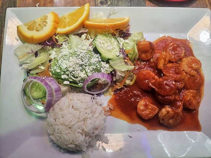 A plate that celebrates color as much as flavor &ndash; spicy shrimp, fresh vegetables, and rice arranged like an edible work of art.