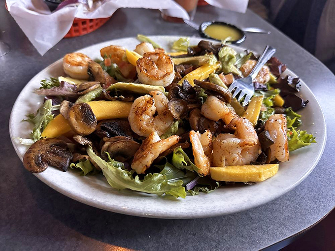 The Cancun Salad brings vacation vibes with perfectly seared shrimp, mango, and greens that somehow make healthy feel indulgent.