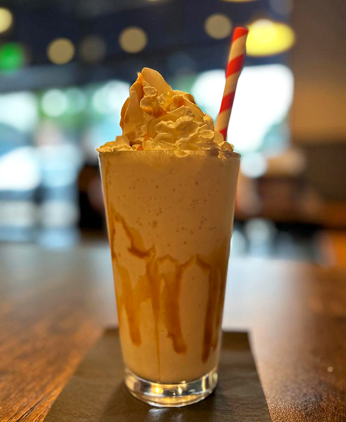 Caramel cascading down glass walls like a sweet waterfall. This isn't just a milkshake&mdash;it's dessert with drinking privileges.
