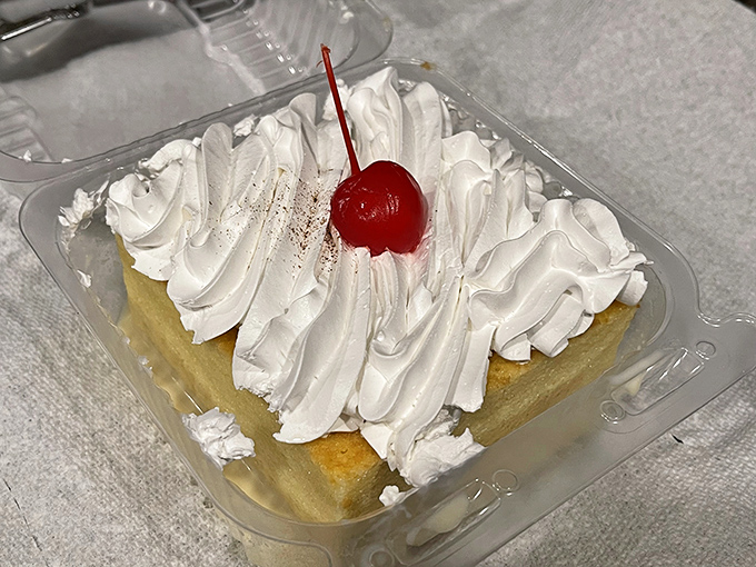 Tres leches cake topped with a cloud of whipped cream and a cherry on top &ndash; the dessert equivalent of finding an unexpected twenty in your winter coat pocket.