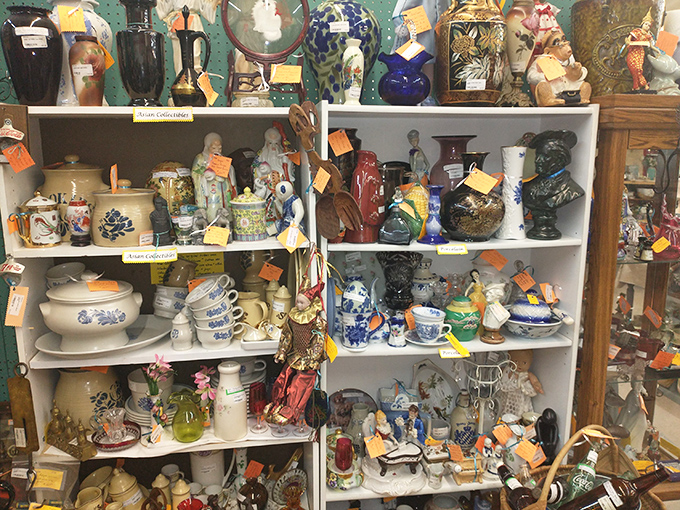 Shelves of ceramics and collectibles stand like a museum of everyday life, each piece whispering stories of dinner parties past.