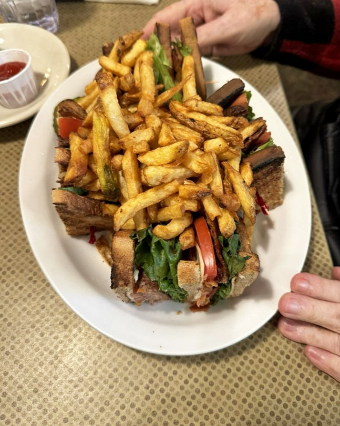 The club sandwich reimagined&mdash;stacked higher than my weekend reading pile and requiring both hands, serious concentration, and zero regrets.