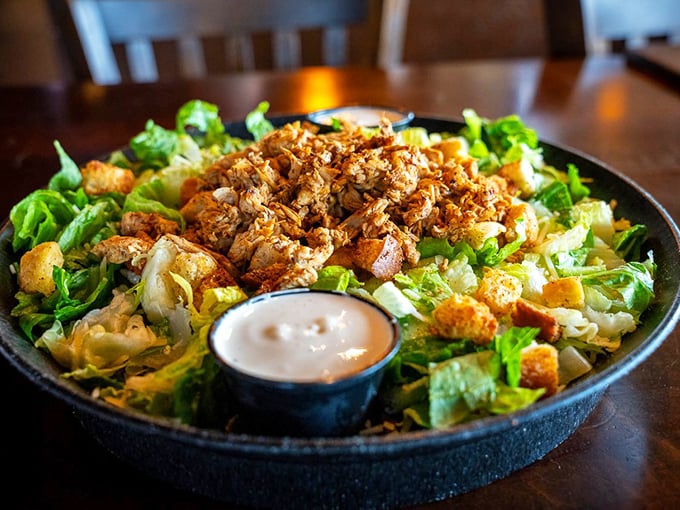 A Caesar salad that actually satisfies. This isn't rabbit food—it's a throne of romaine crowned with seasoned chicken that would impress Julius himself.