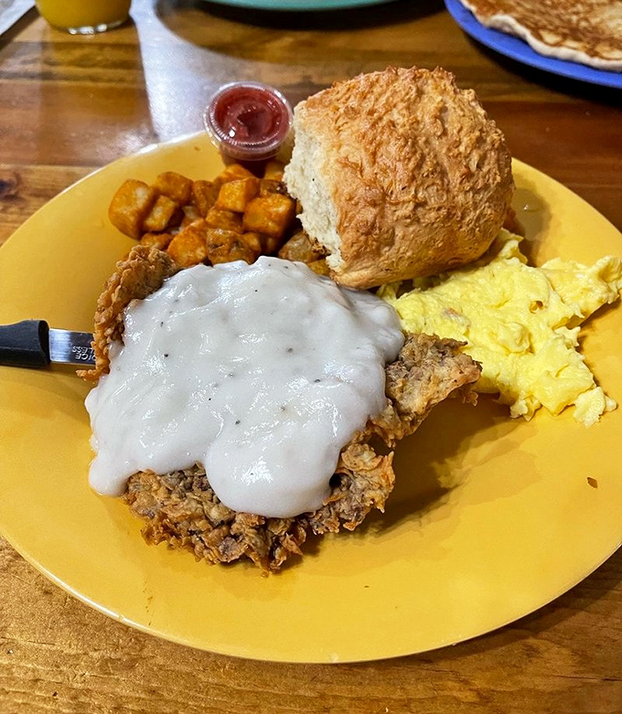 Chicken fried steak smothered in gravy alongside a biscuit that could make a grown Texan weep. Breakfast doesn't get more serious than this. 