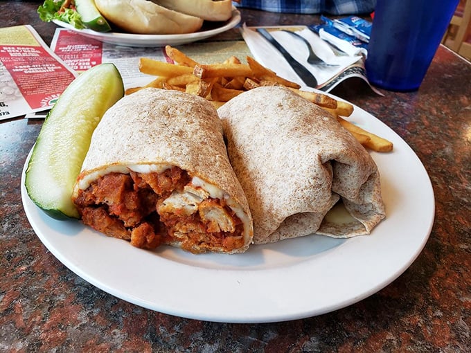 This chicken wrap isn't just lunch&mdash;it's a portable feast wrapped in a warm tortilla, with crispy fries standing guard like delicious sentinels.