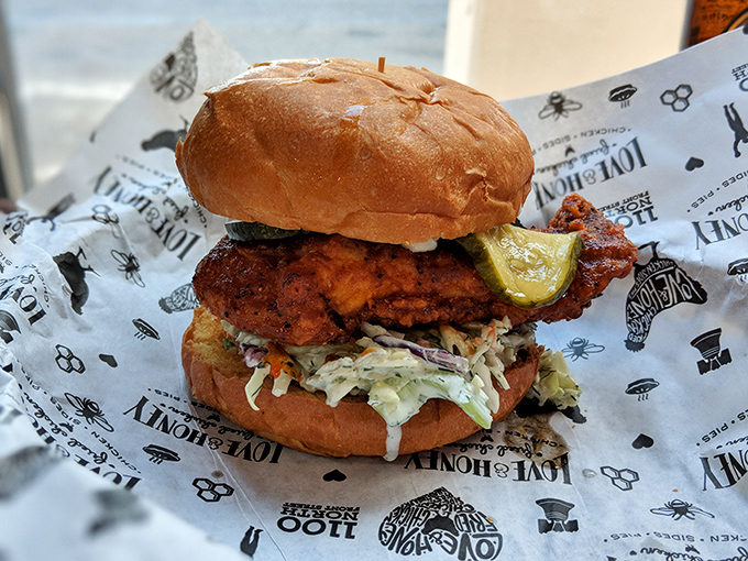 A sandwich that requires both hands and your full attention. That pickle perched on top isn't just garnish&mdash;it's the perfect acidic counterpoint.