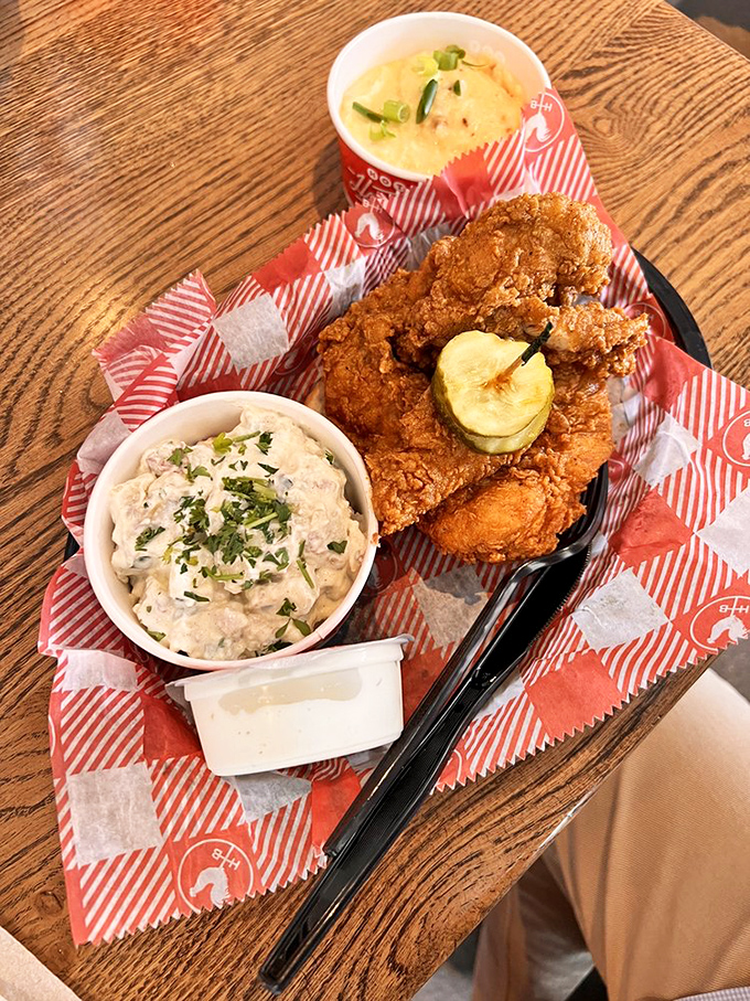 A holy trinity of Southern comfort: golden-fried chicken, creamy potato salad, and mac and cheese that could make a grown man weep.