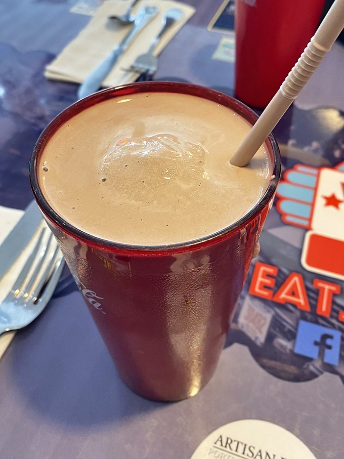 This chocolate frappe isn't just a milkshake&mdash;it's a commitment. Served in that classic Coca-Cola glass, it's thick enough to require serious straw technique and zero regrets.