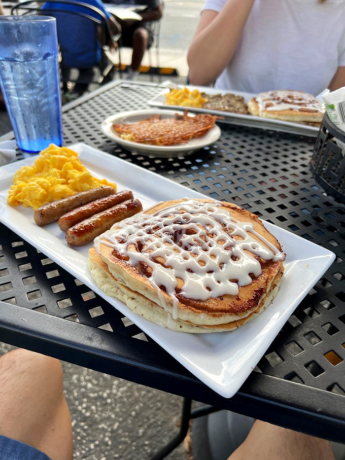 A cinnamon roll pancake with artistic white icing crosshatching. Somewhere, a pastry chef and a breakfast cook are high-fiving over this beautiful collaboration.