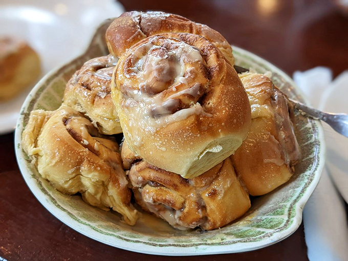 Cinnamon rolls stacked higher than your weekend to-do list, each one glistening with glaze that's worth every sticky finger.