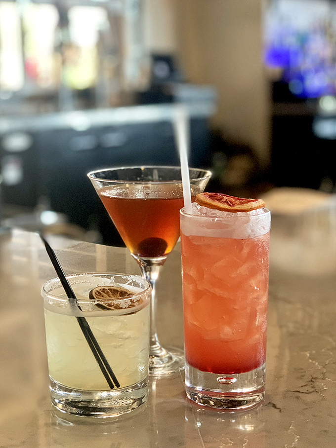 Cocktails that look as good as they taste—like liquid jewelry catching the light. That pink concoction is calling my name from across the room.