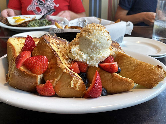 French toast transformed into a dessert island paradise, where berries and ice cream have found their forever home.