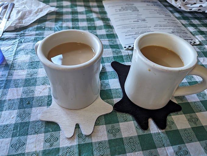 Two coffee mugs on star-shaped coasters&mdash;because even caffeine deserves a stage. In Nebraska, coffee isn't a beverage; it's a relationship.