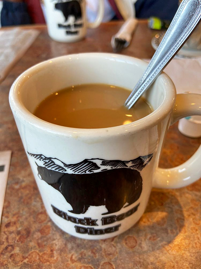 The humble coffee mug, adorned with the restaurant's iconic bear, promises liquid fortification for the pancake marathon that lies ahead.