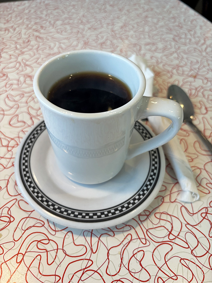Simple pleasures: diner coffee in a white mug with that distinctive black-rimmed pattern&mdash;the universal symbol for "refills welcome."