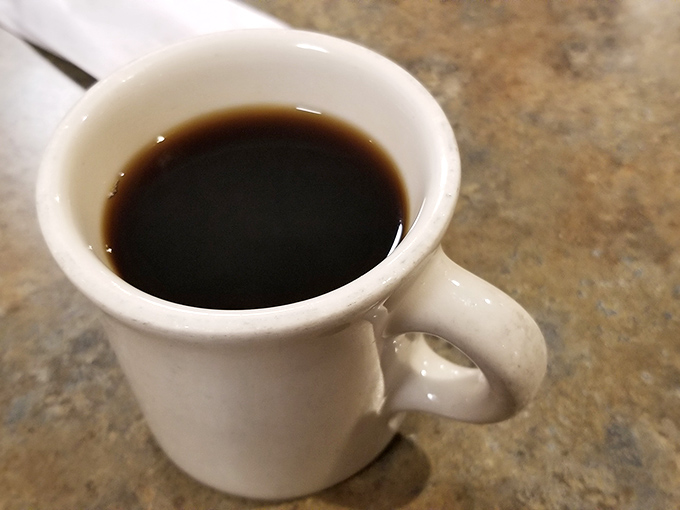 The coffee comes in those iconic thick white mugs that somehow make everything taste better. This isn't artisanal pour-over&mdash;it's the reliable fuel of America.