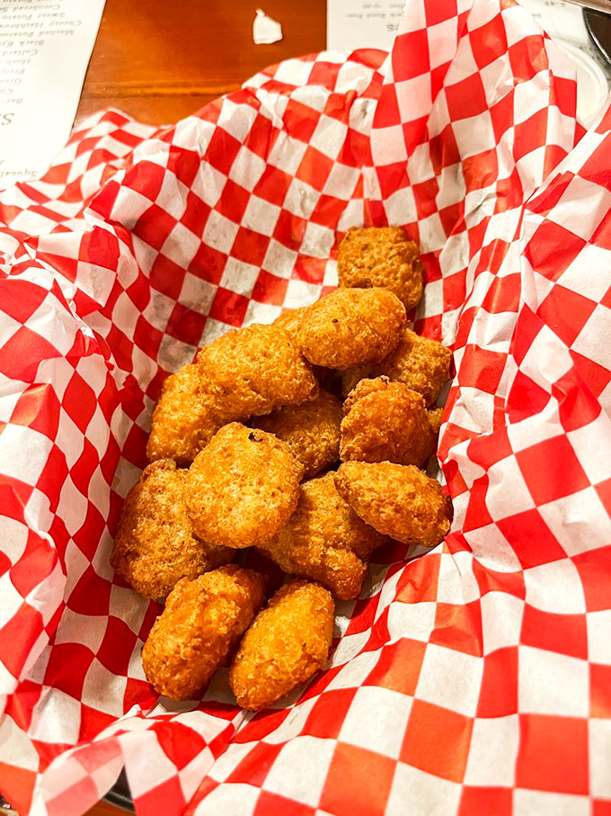 Golden-fried corn nuggets nestled in their checkered paper cradle &ndash; little bombs of sweetness with a crispy exterior that defies resistance.