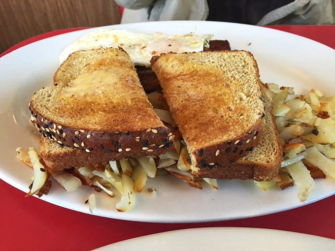 Toast perched atop a mountain of corned beef hash like climbers who've conquered breakfast Everest. The crispy potatoes form base camp below. 