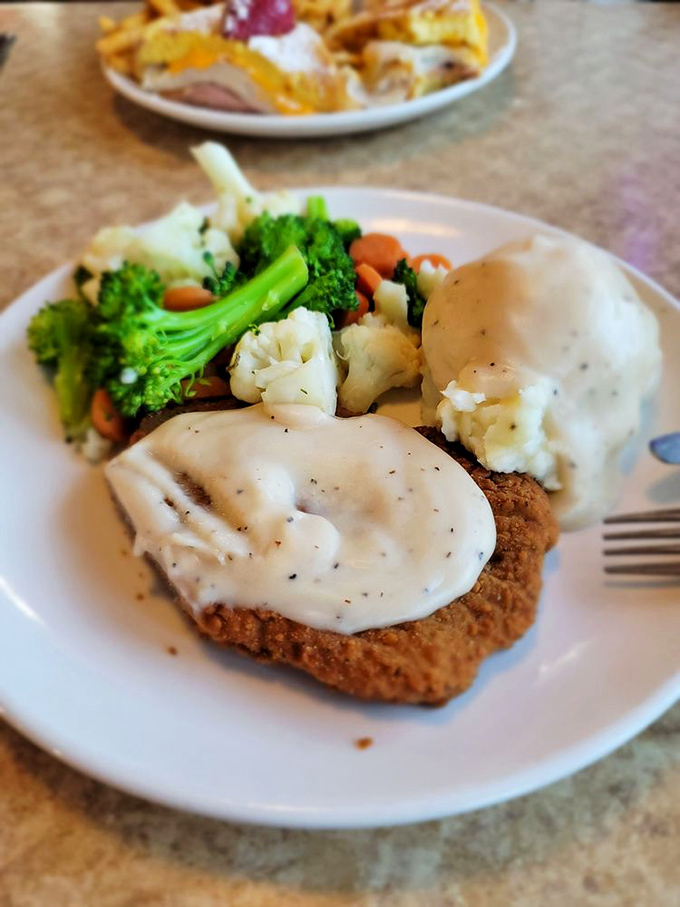 Country fried steak smothered in gravy with a rainbow of vegetables. Southern comfort meets California fresh in perfect harmony.