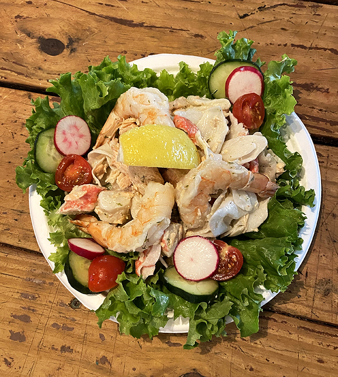 This seafood salad isn't just lunch&mdash;it's a refreshing celebration of the ocean's bounty, arranged atop crisp greens with the perfect touch of color.