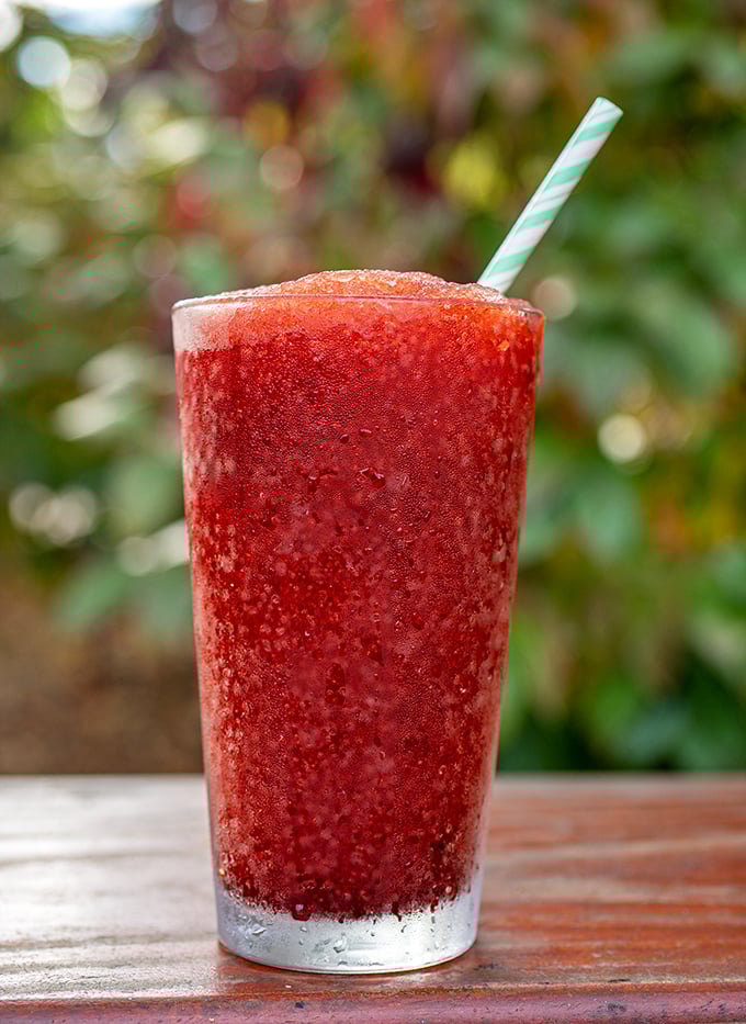 The frozen strawberry concoction that makes you forget you just voluntarily set your mouth on fire. Sweet, cold redemption in a glass.
