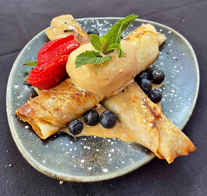 Thin crepes cradle dulce de leche alongside fresh berries and a scoop of something heavenly. Dessert architecture at its most deliciously unstable.