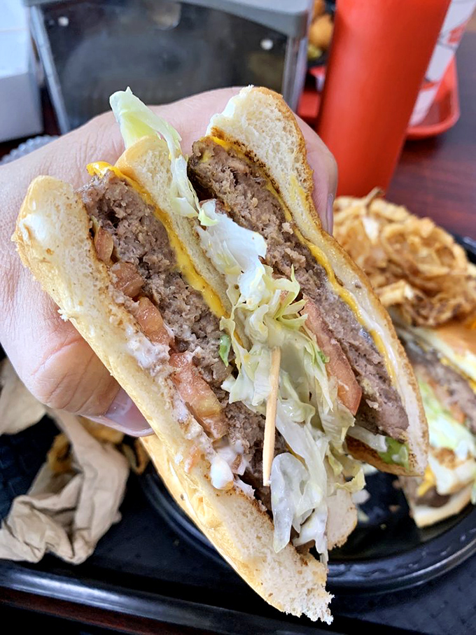 The double cheeseburger cross-section reveals the architectural marvel that keeps Spartanburg residents coming back despite what their doctors might advise.