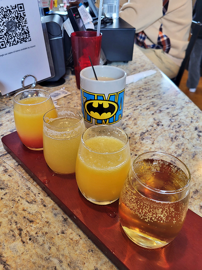 Mimosa flight? Don't mind if I do! Breakfast cocktails that make adulting worthwhile, served alongside coffee in a Batman mug.
