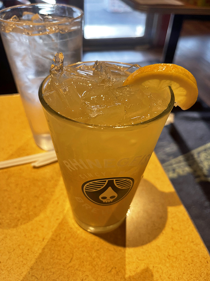 A refreshing adult beverage with a lemon slice &ndash; because sometimes hot dog adventures require proper hydration with a hint of sophistication.