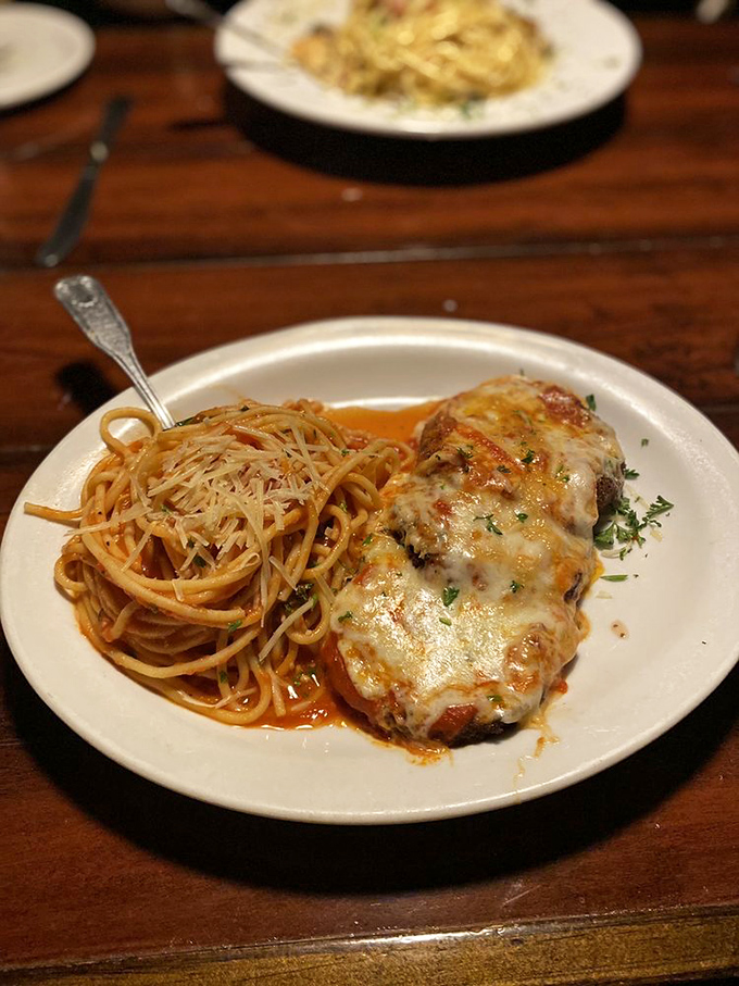 Eggplant parmesan that's achieved the impossible trifecta: crispy exterior, tender interior, and enough cheese to make Wisconsin nervous.