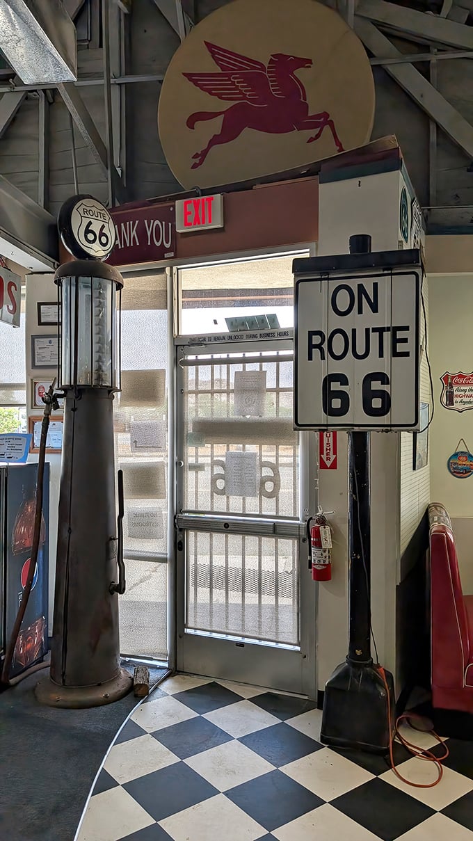 The exit sign says "THANK YOU" because even the doorway is polite here. Classic gas pump and checkerboard floor&mdash;pure Americana distilled.