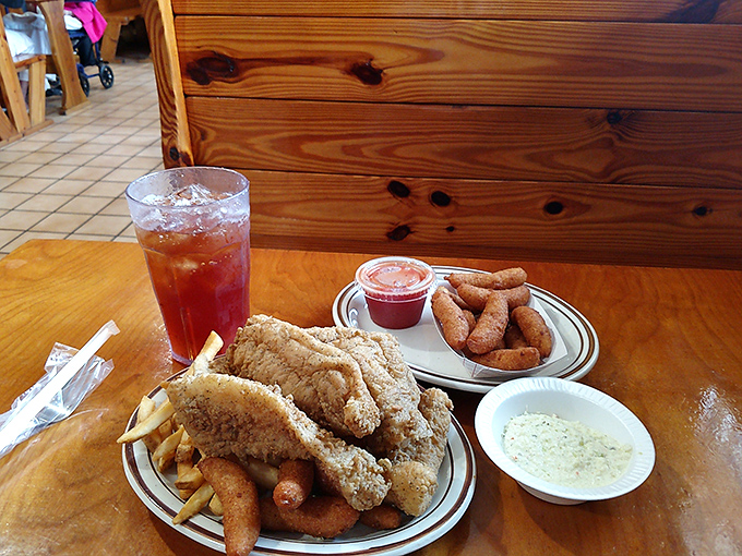 The complete seafood experience: golden fish, crispy hushpuppies, and sweet tea so good it deserves its own area code in North Carolina.