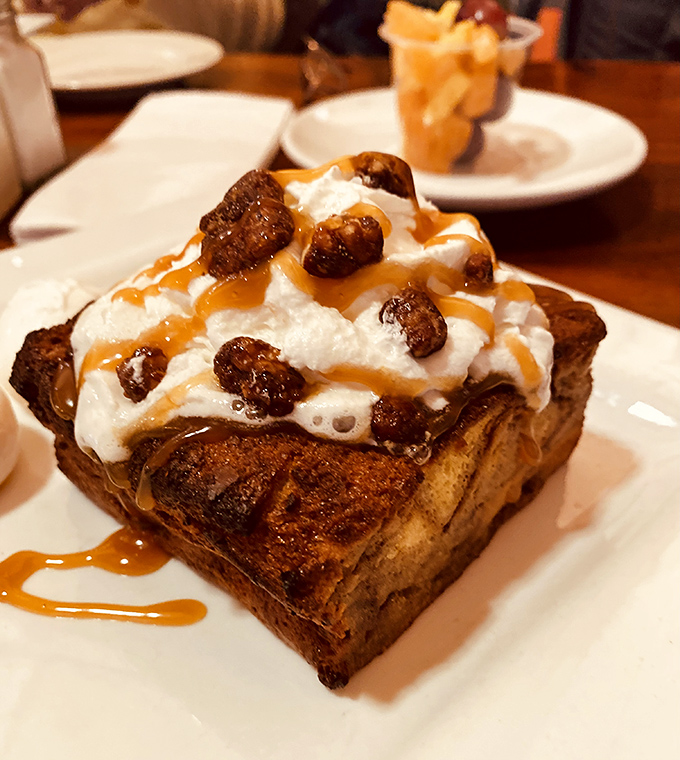Bread pudding that's had a glow-up&mdash;crispy edges, pillowy center, topped with whipped cream and caramel that transforms breakfast into dessert heaven.