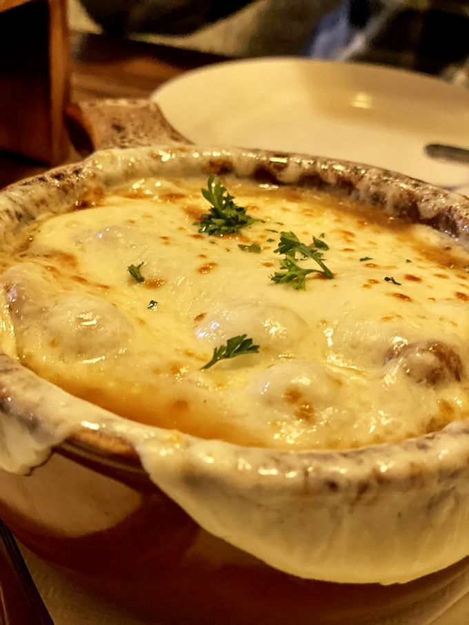 French onion soup that's achieved the golden trifecta: sweet caramelized onions, savory broth, and a cheese cap that stretches with each spoonful.
