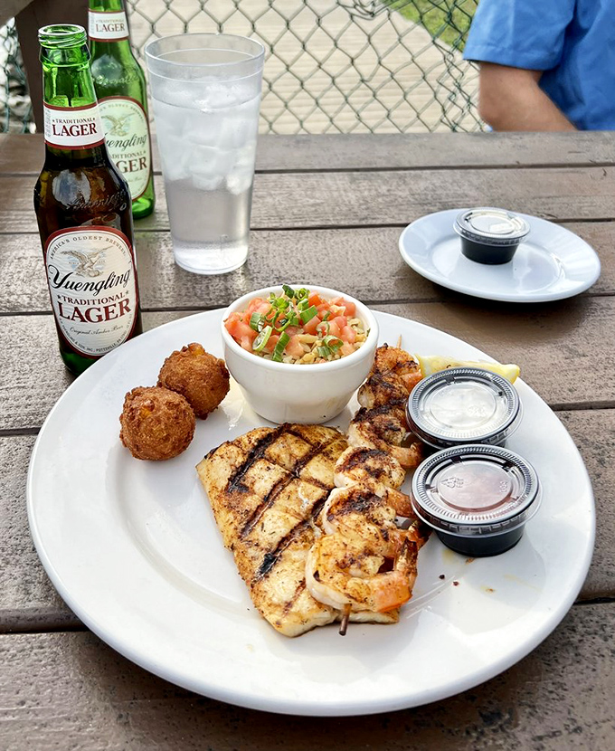 Perfectly grilled fish alongside hushpuppies and slaw&mdash;proof that sometimes the simplest preparations let the freshness of Gulf seafood shine brightest.