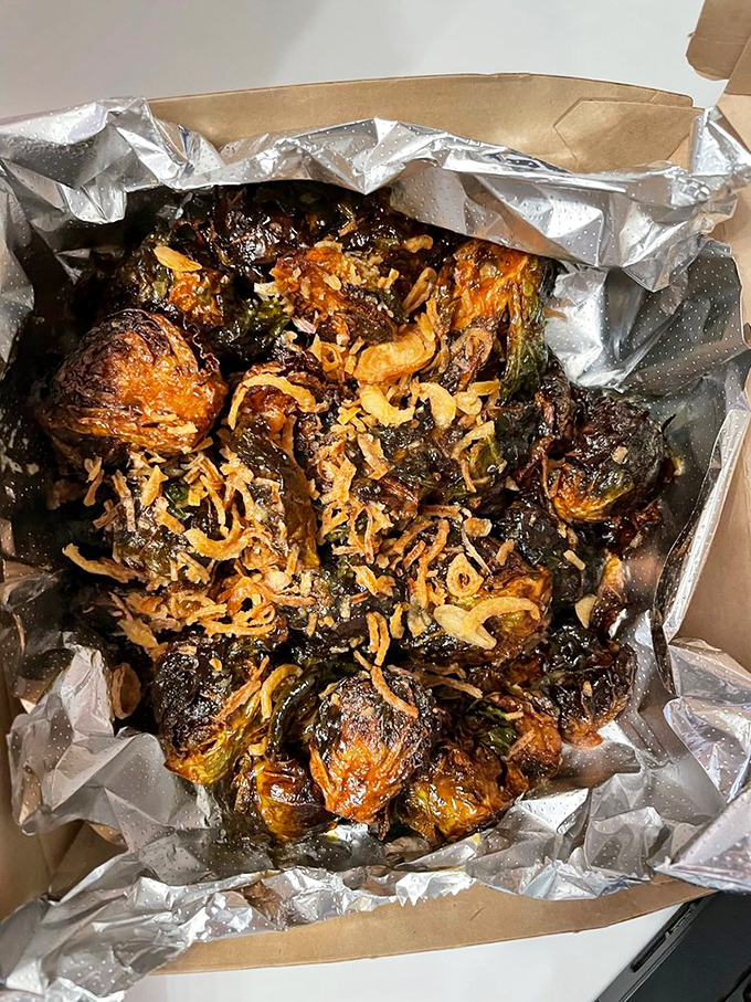 Brussels sprouts transformed from childhood nightmare to adult obsession, caramelized and crispy with what appears to be magical flavor dust.