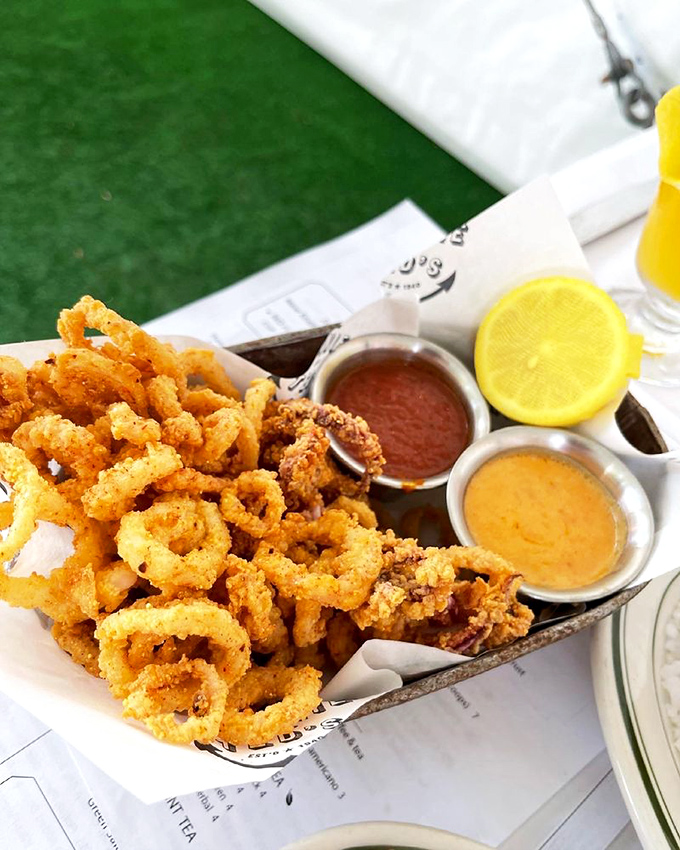 Fried calamari that achieves the impossible: golden-crisp exterior while remaining tender within. Those dipping sauces are about to become your new best friends.