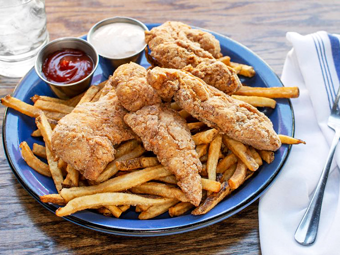 Chicken tenders that make adults forget they ordered from the "grown-up menu," served with fries that demand to be dunked.