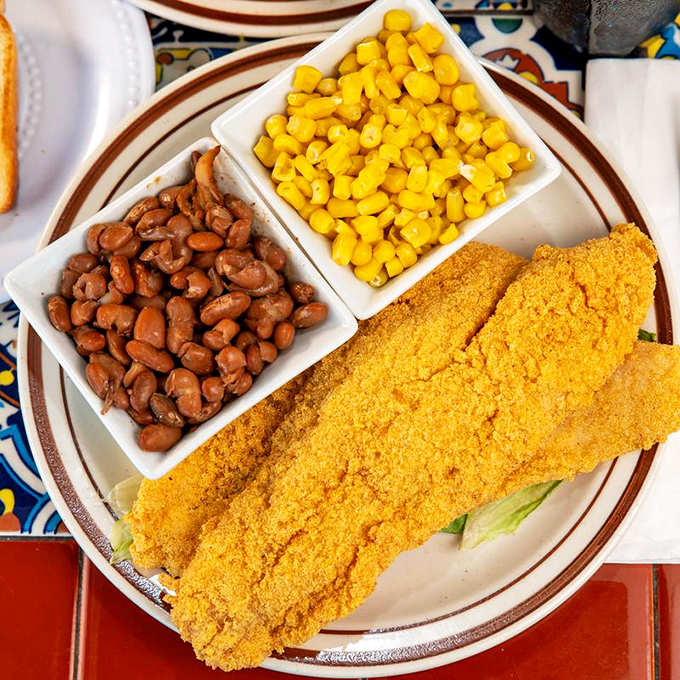 Crispy cornmeal-crusted catfish with sides of beans and corn—proof that diners know how to do lunch just as well as breakfast.