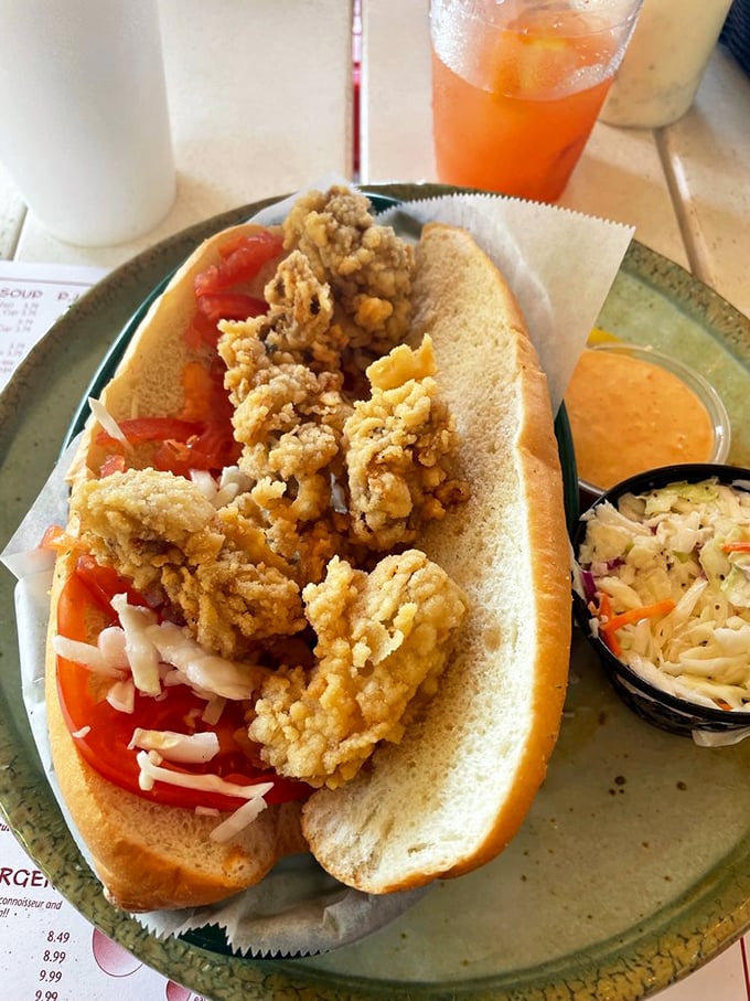 This fried oyster po'boy isn't just a sandwich &ndash; it's a textural masterpiece where crispy, briny treasures meet soft bread in perfect harmony.