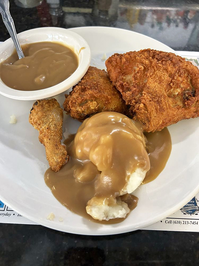 Fried chicken and mashed potatoes swimming in gravy&mdash;the kind of plate that makes you want to hug the cook and call your cardiologist.
