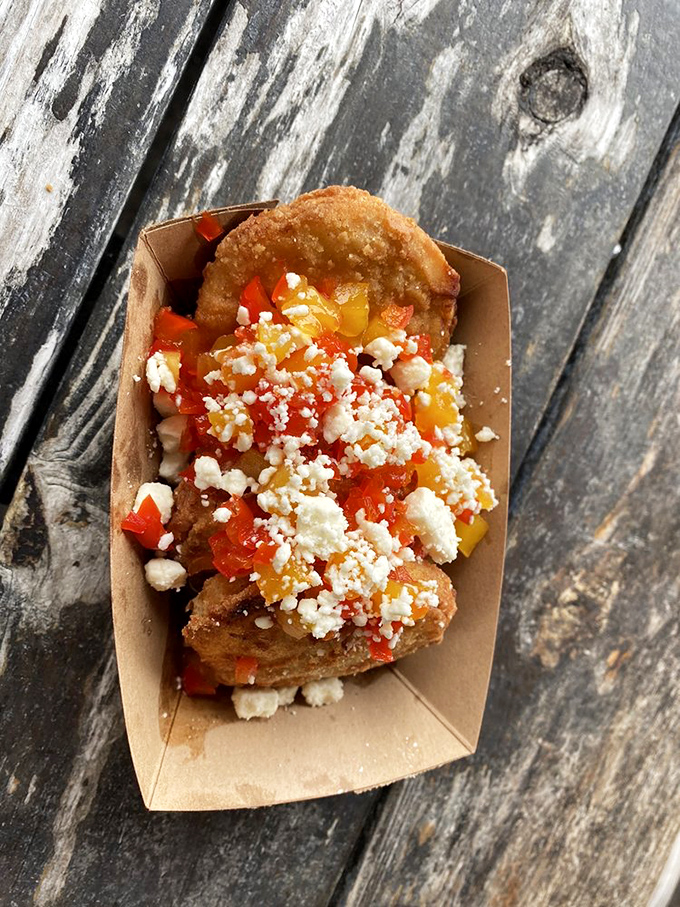 Fried green tomatoes topped with crumbled feta and diced peppers&mdash;Southern tradition getting a coastal makeover that would make your grandmother both confused and delighted.