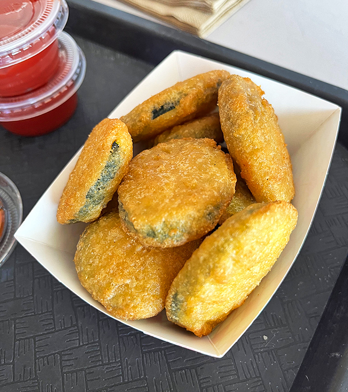 Fried pickles: proof that anything becomes magical when battered and fried. Tangy, crunchy little discs of joy that disappear faster than desert rain.