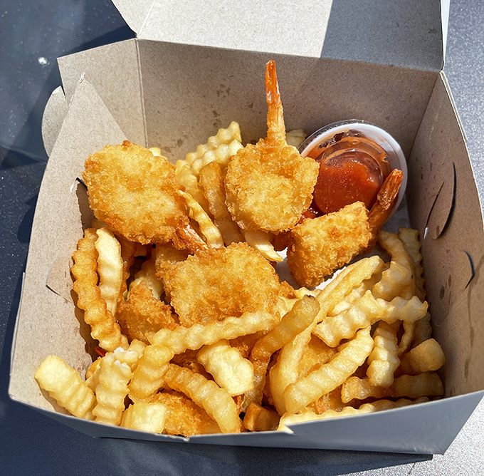 Golden-fried shrimp nestled among crinkle-cut fries—a seafood interlude in chicken country that proves Fast Eddie's fryer doesn't discriminate against oceanic delights.